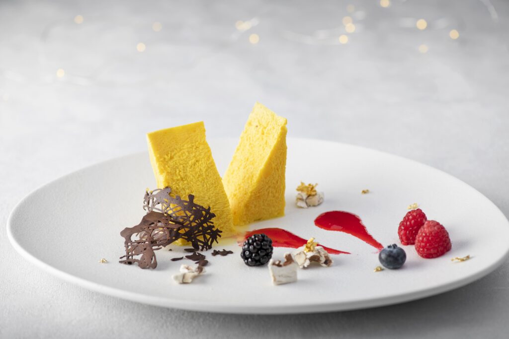 Nougat and saffron gold parfait, red fruit coulis